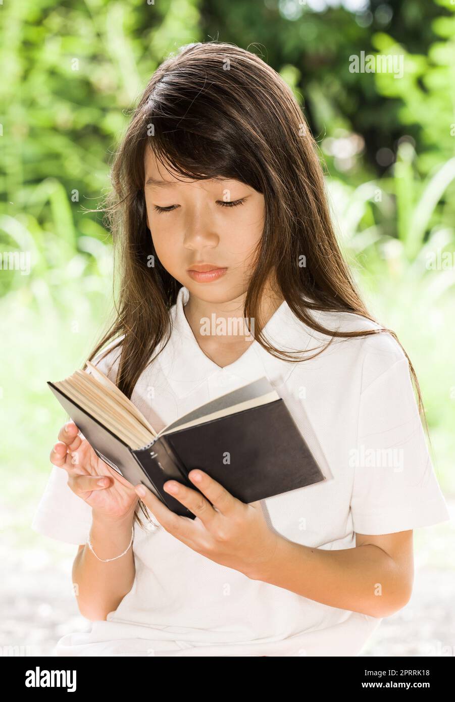 Asian girl reading book Stock Photo - Alamy