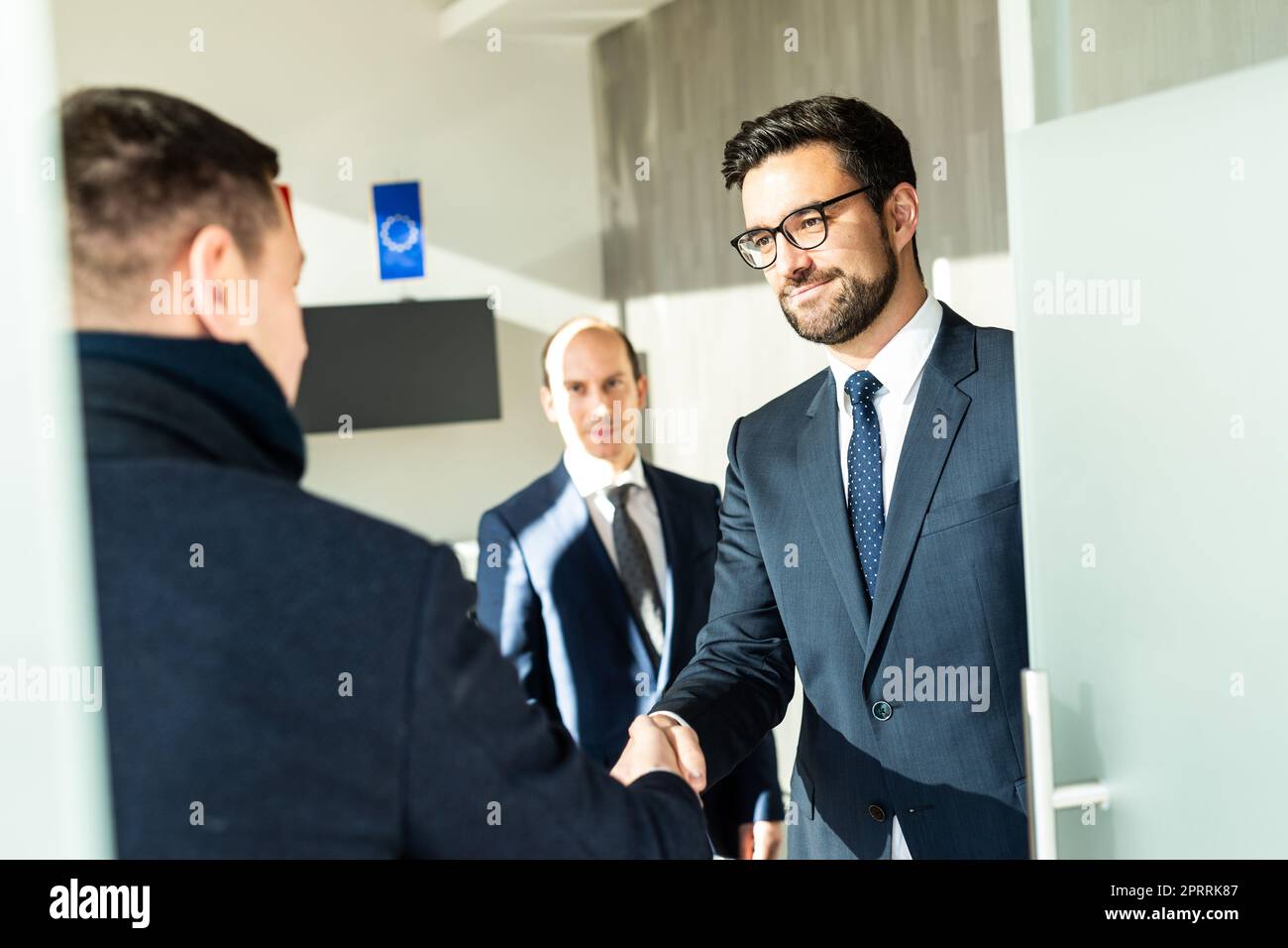 Group of confident business people greeting with a handshake at ...