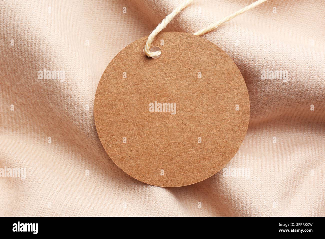 Circle shaped tag with space for text on beige fabric, top view Stock ...