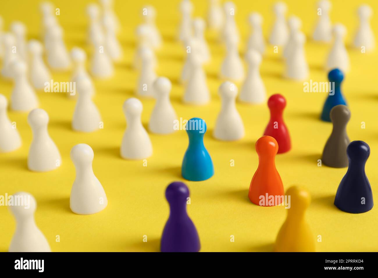 Colorful pawns on yellow background, closeup. Social inclusion concept ...