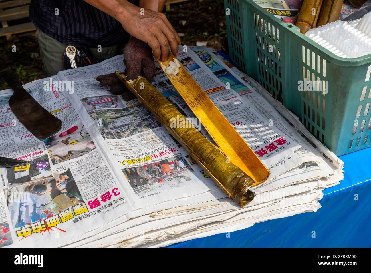 Malaysian man cooking rice in bamboo tube. It is also called Bamboo ...