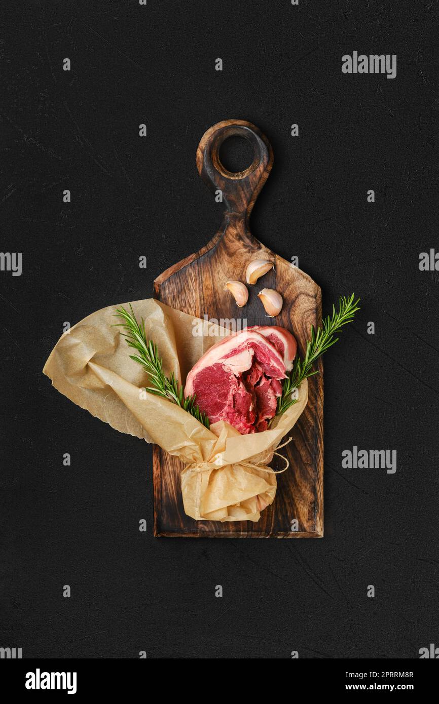 Raw lamb double loin chop wrapped in paper Stock Photo - Alamy