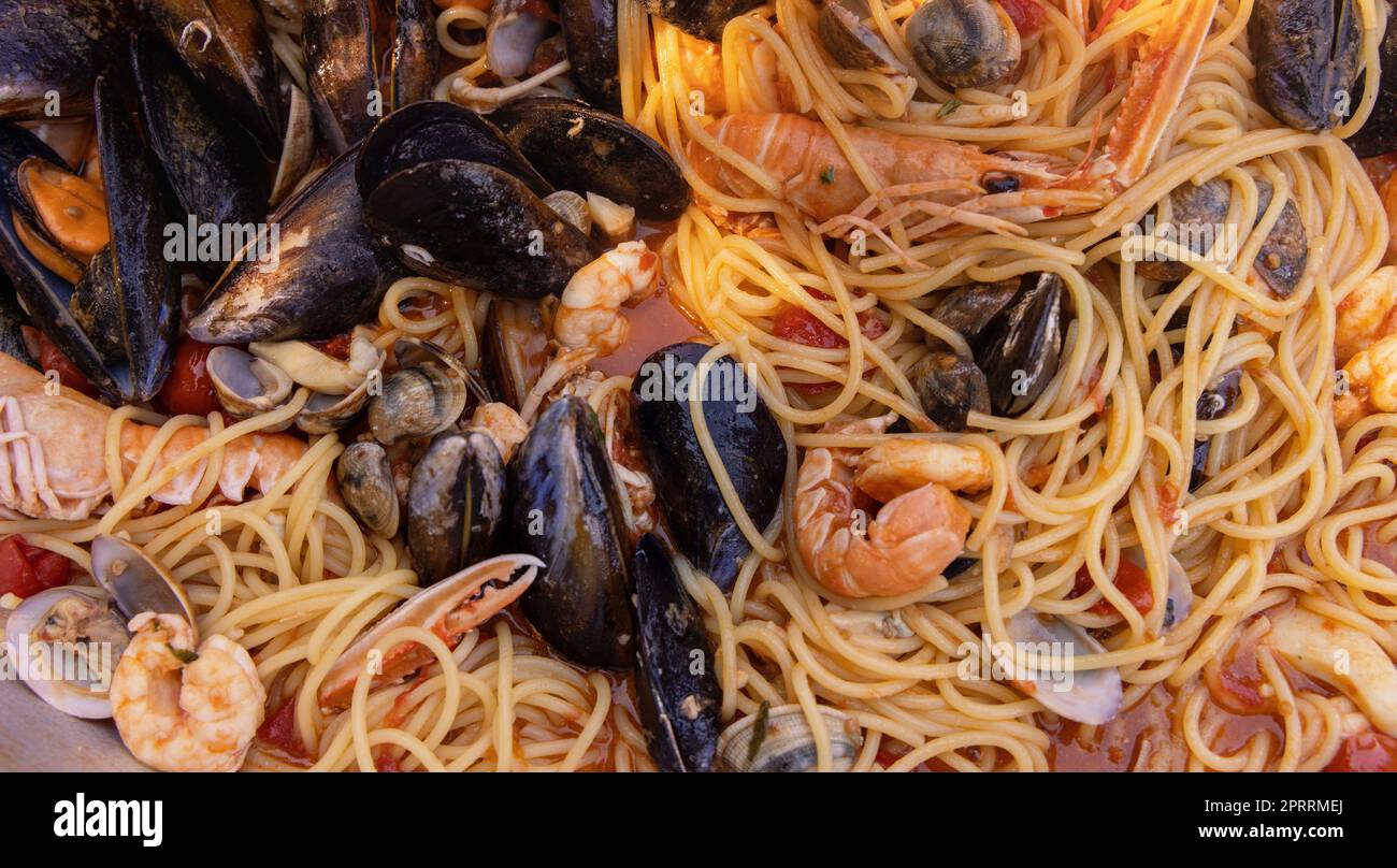 Italian spaghetti allo scoglio, pasta with seafood and tomatoes close ...