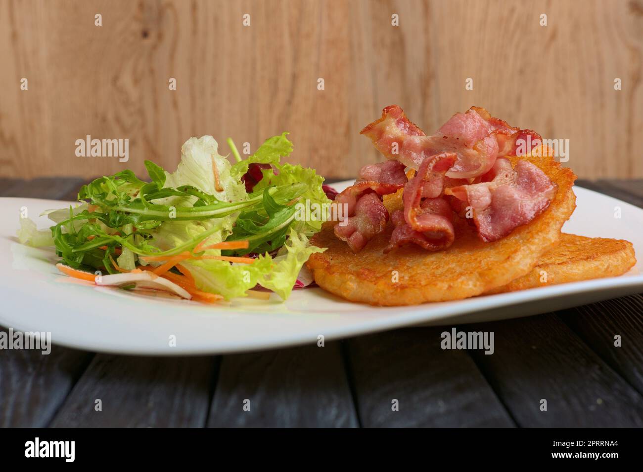 Traditional russian draniki with bacon and salad Stock Photo - Alamy
