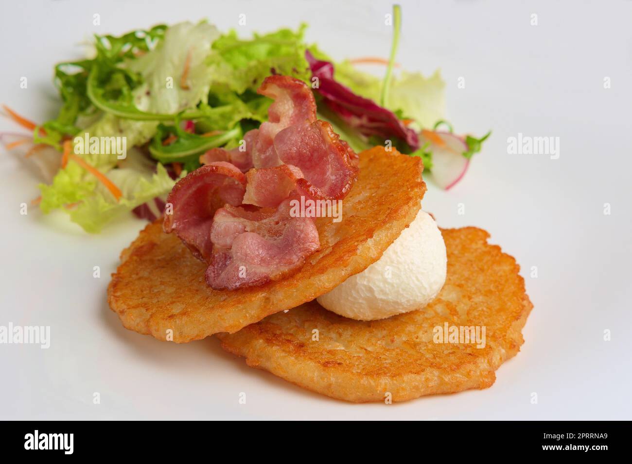 Traditional russian draniki with bacon and salad Stock Photo - Alamy