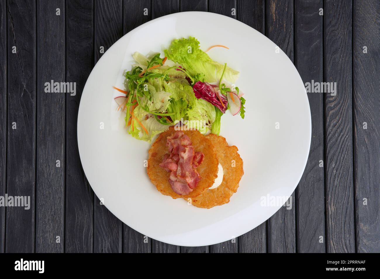 Traditional russian draniki with bacon and salad. Top view Stock Photo ...