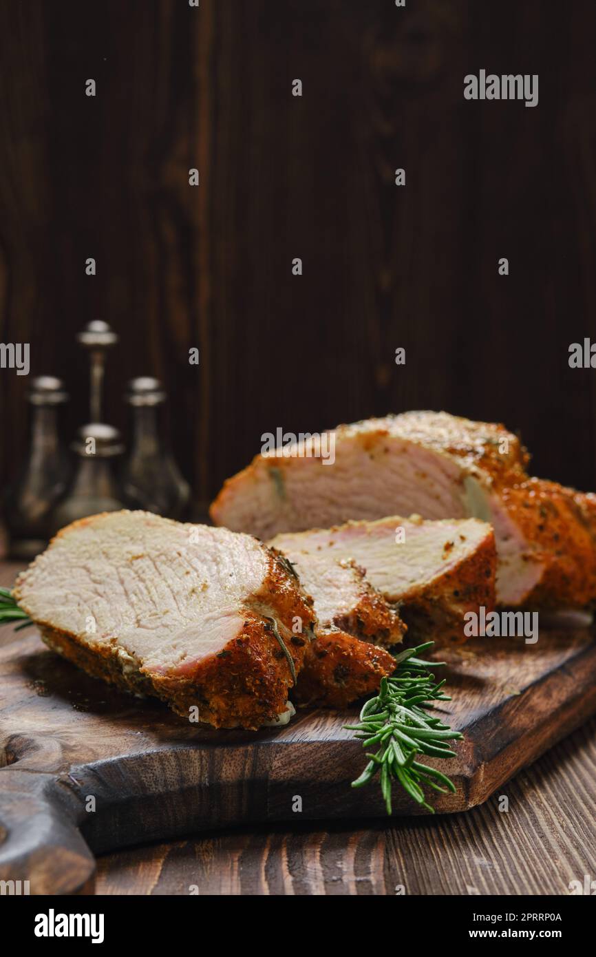 Closeup view of pork collar joint baked in oven on wooden serving board ...