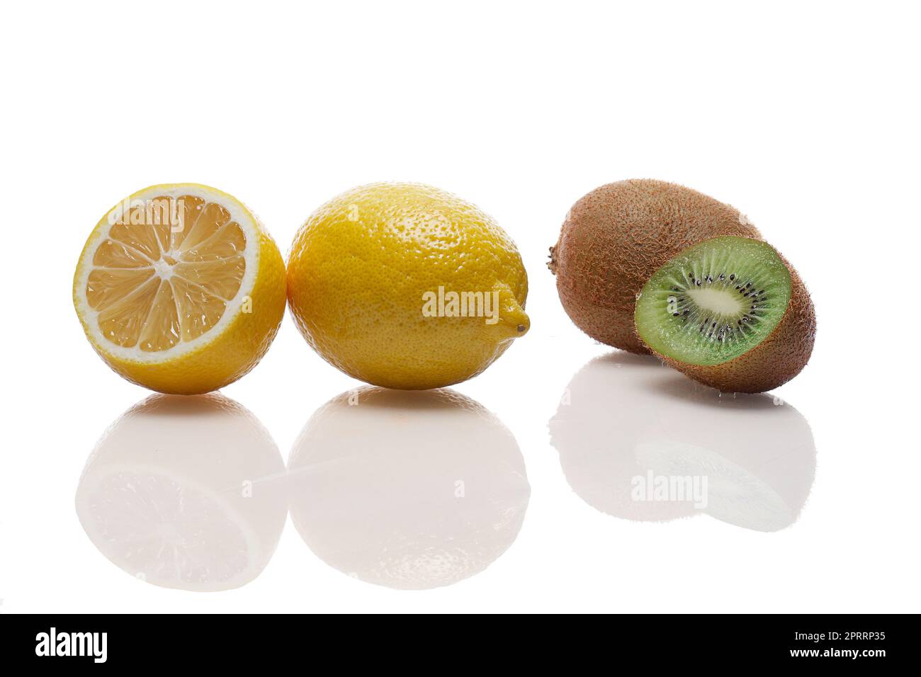 One whole and one half of lemon and kiwi with reflection on white glass ...