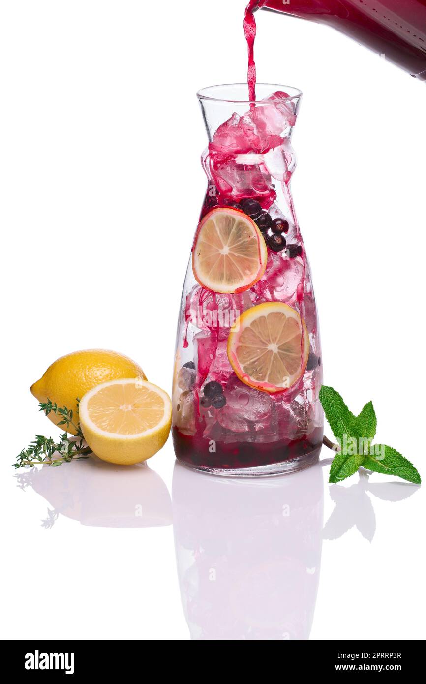 Pouring in jug with ice black currant drink Stock Photo - Alamy