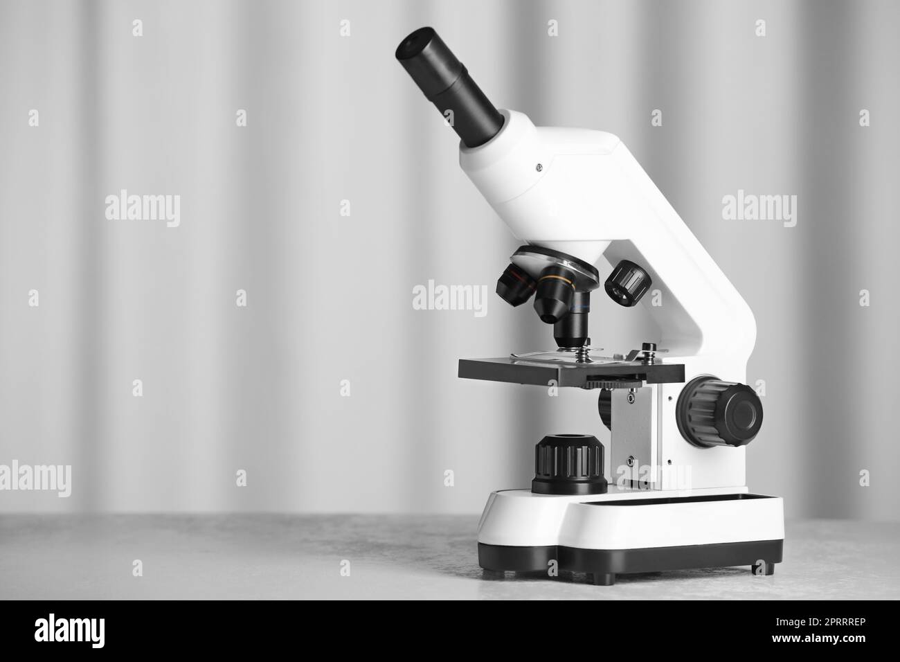 Modern microscope on table indoors. Space for text Stock Photo - Alamy