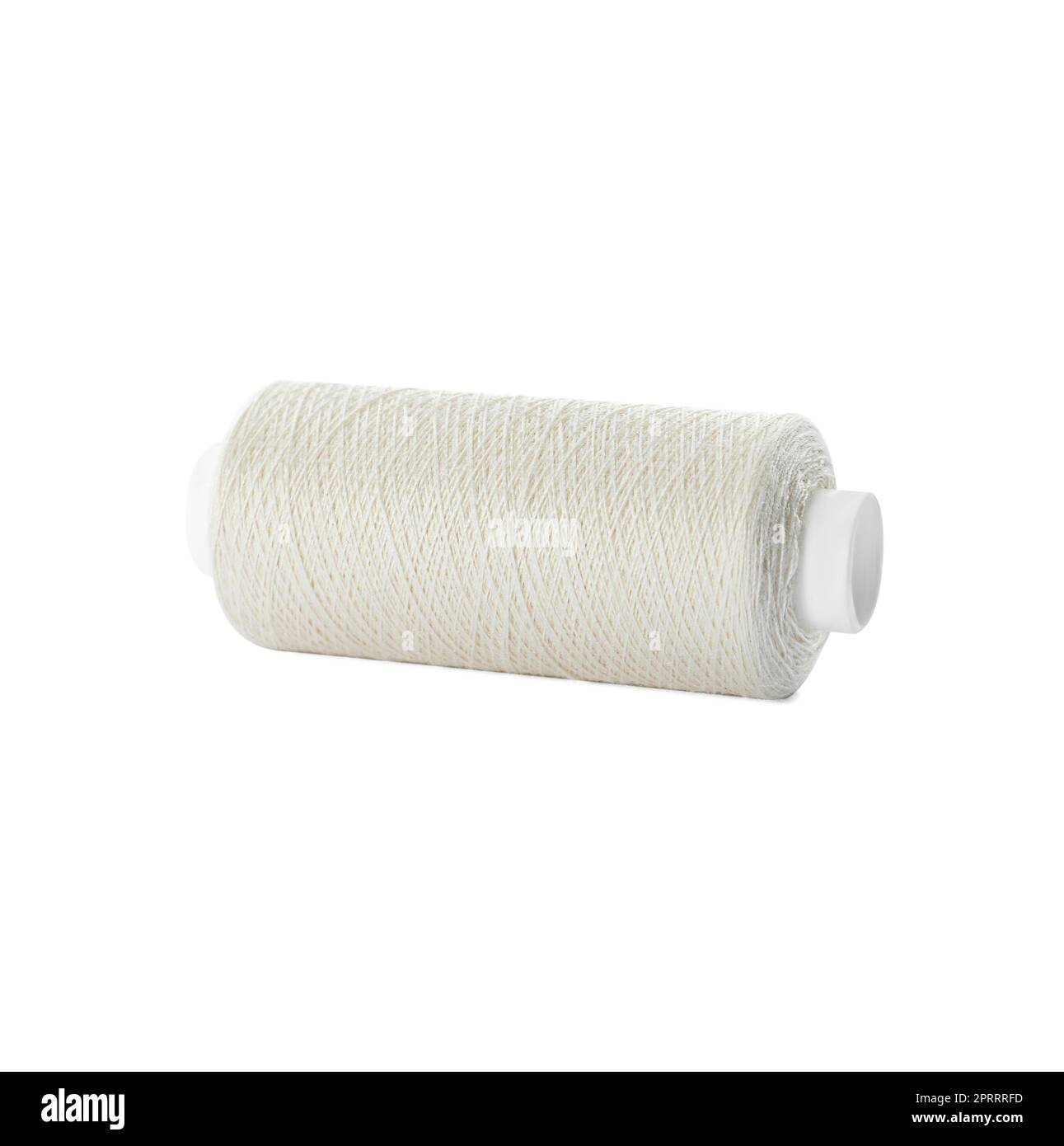 Spool of beige sewing thread isolated on white Stock Photo - Alamy