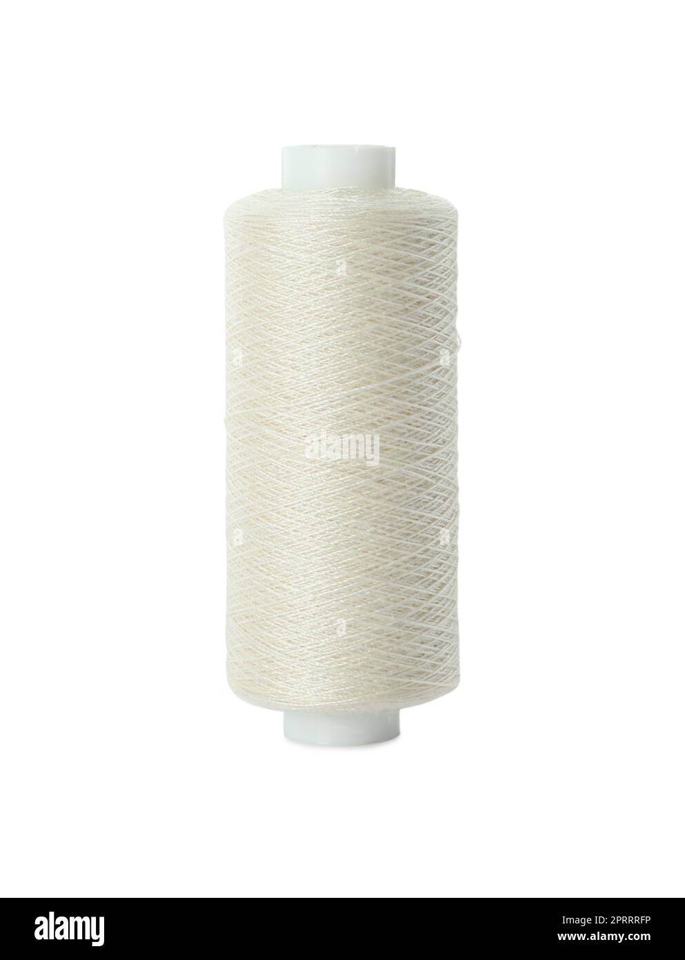 Spool of beige sewing thread isolated on white Stock Photo - Alamy
