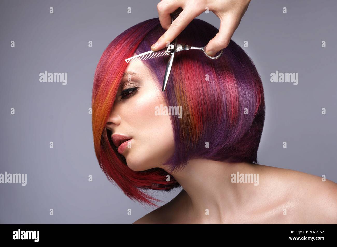 Portrait of beautiful woman with multi-colored hair and creative make ...