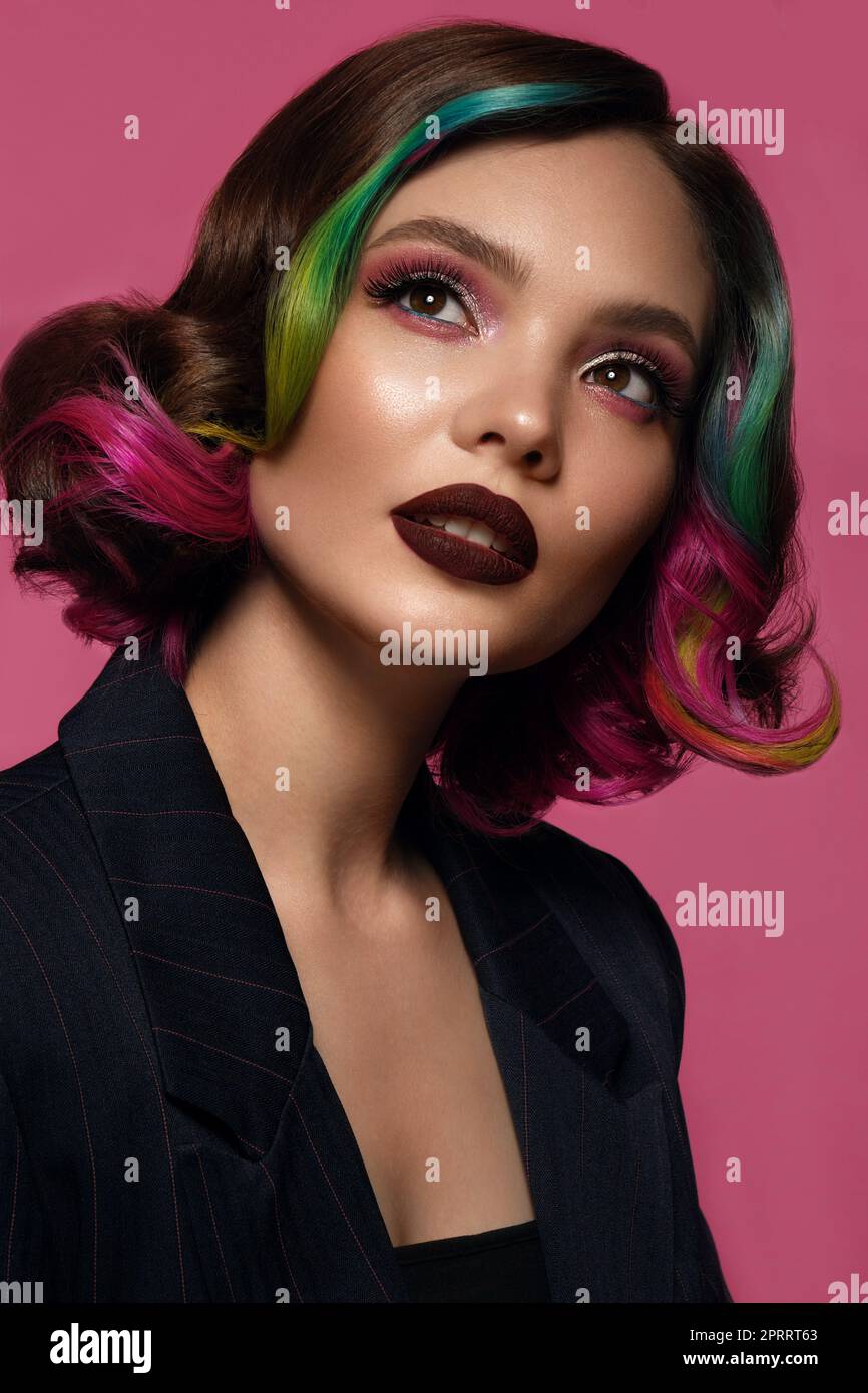 Portrait of beautiful woman with multi-colored hair and evening make-up ...