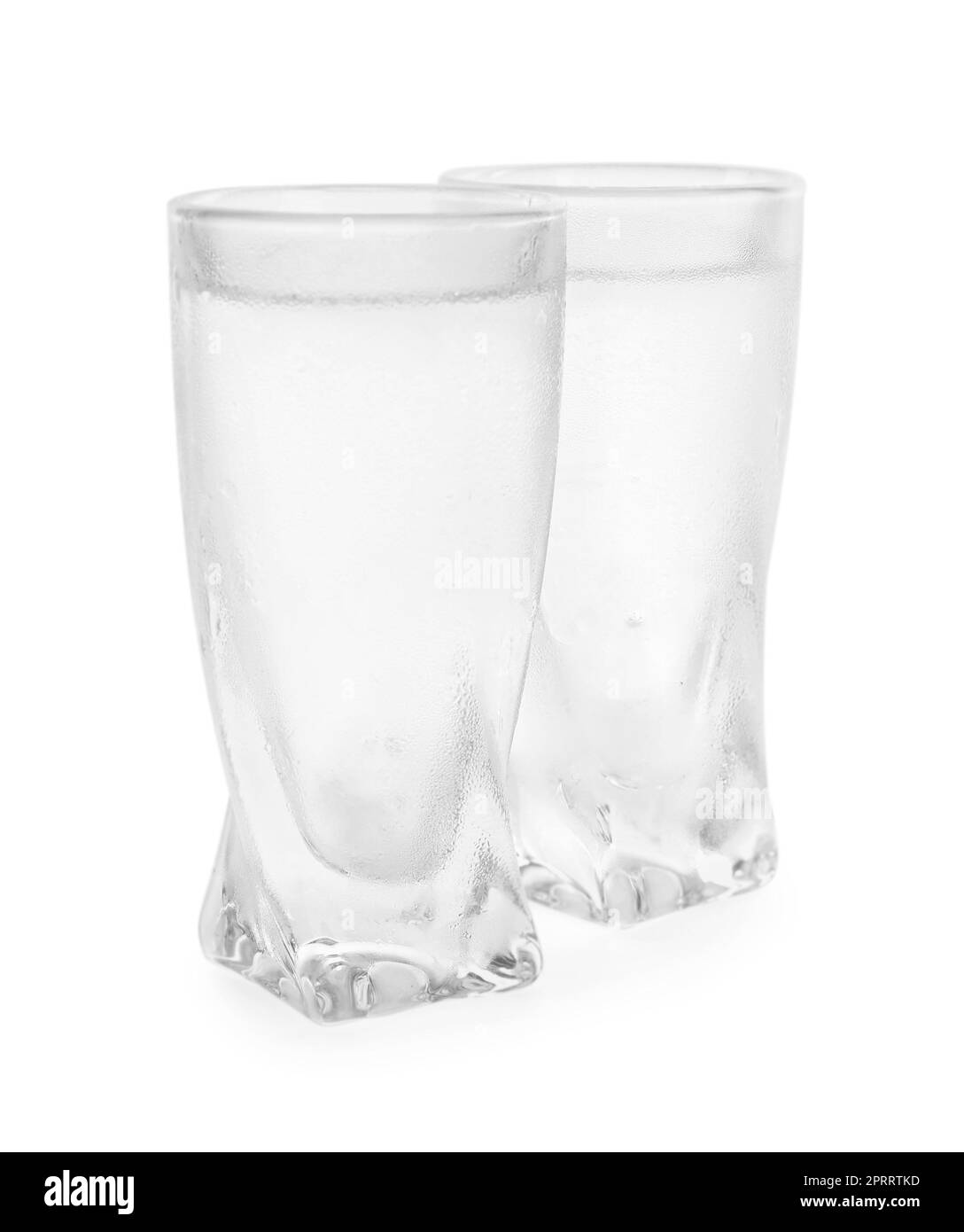 Vodka in shot glasses on white background Stock Photo - Alamy