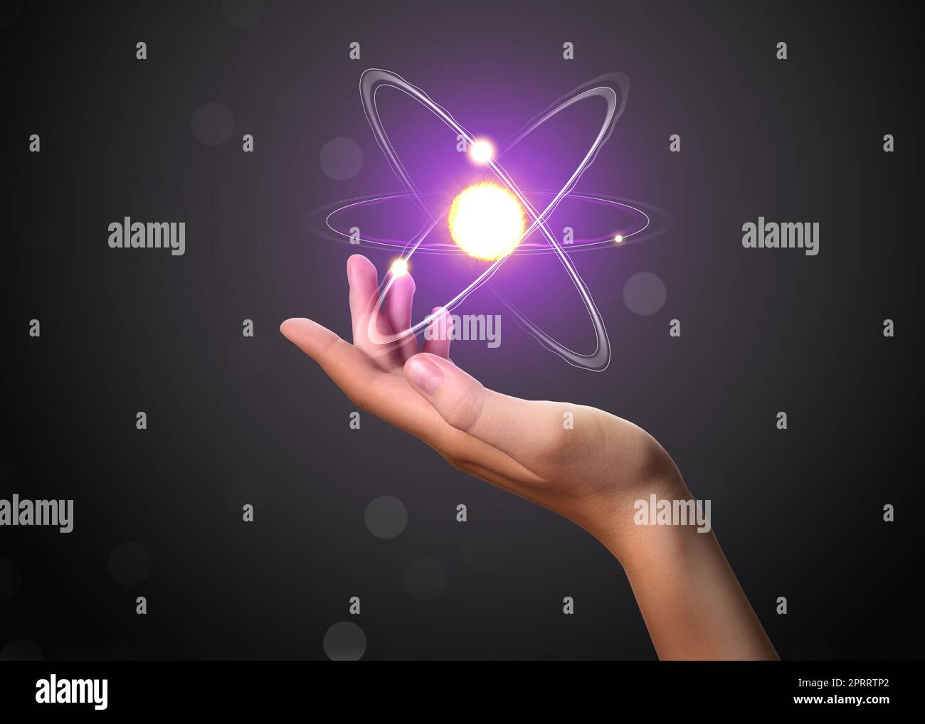Woman and virtual model of atom on dark background, closeup Stock Photo ...