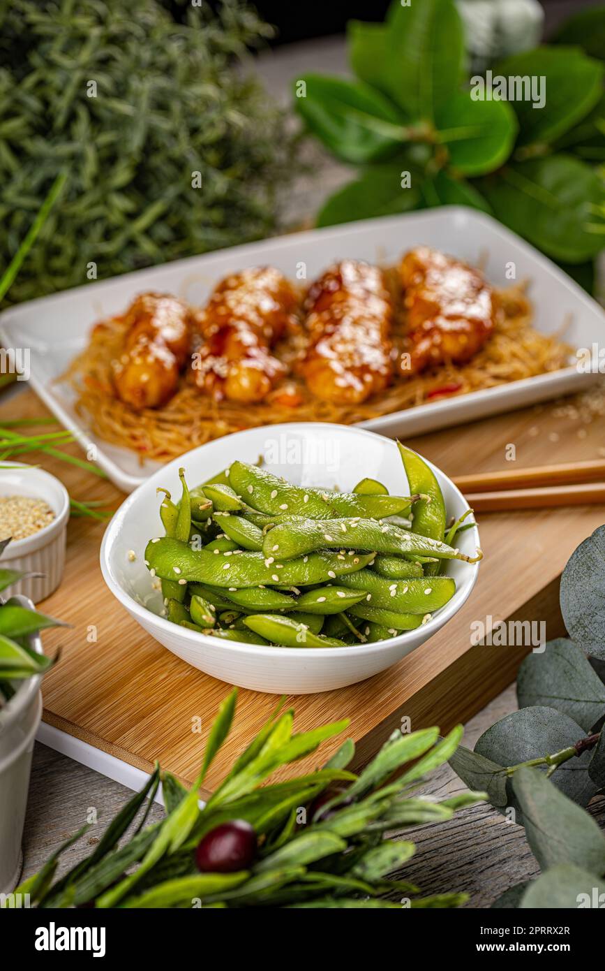 Asian style food concept with green sweet pea pods with honey chicken ...