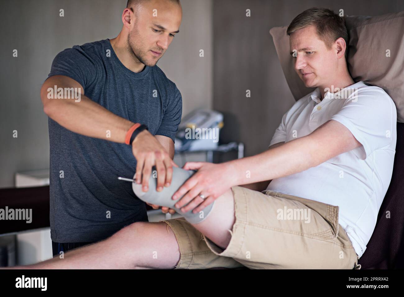 Lets take a closer look. a physiotherapist examining a man with an ...