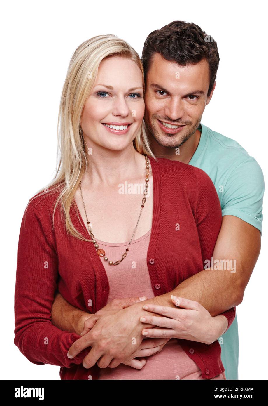Safe in his arms. An attractive couple smiling at the camera against a ...