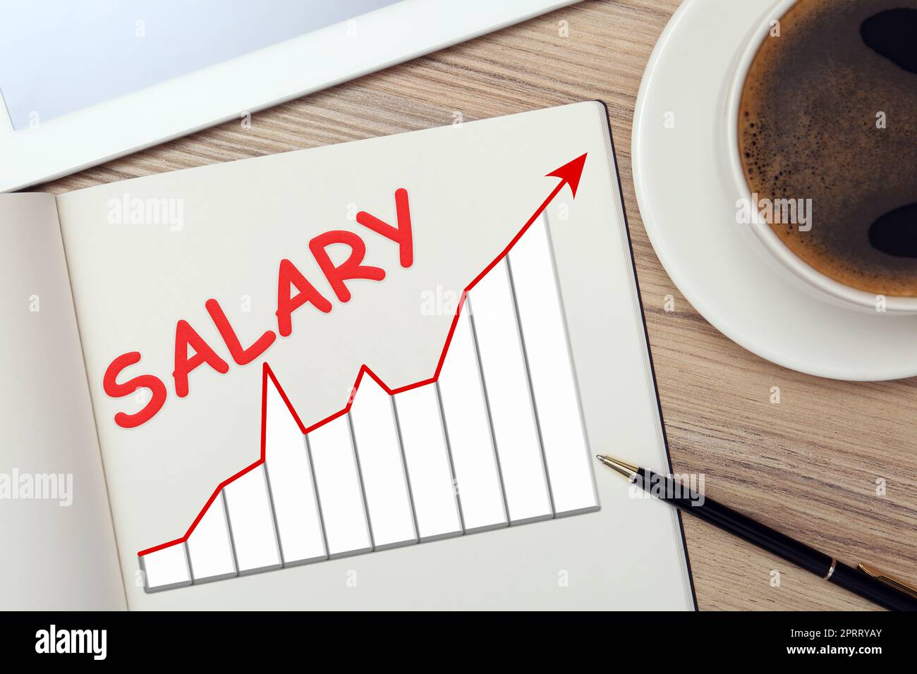Salary increase concept. Up arrow and growing charts drawn in notebook ...