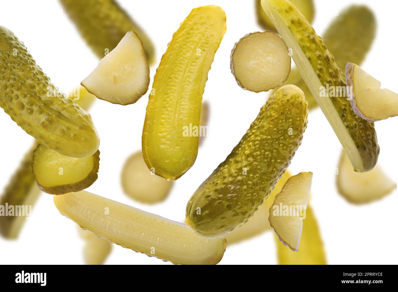Tasty pickled cucumbers falling on white background Stock Photo - Alamy