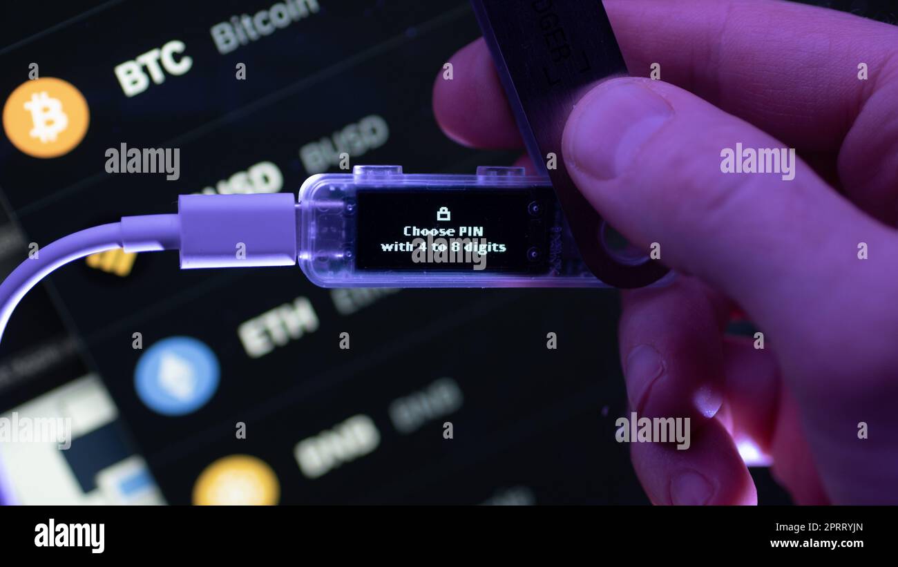 Focus on the screen of an hardware wallet Ledger, the Metamask logo in ...