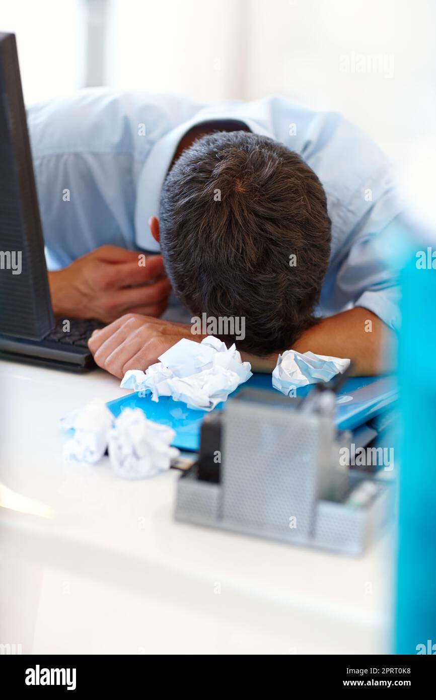 Head on desk with balls of paper hi-res stock photography and images ...