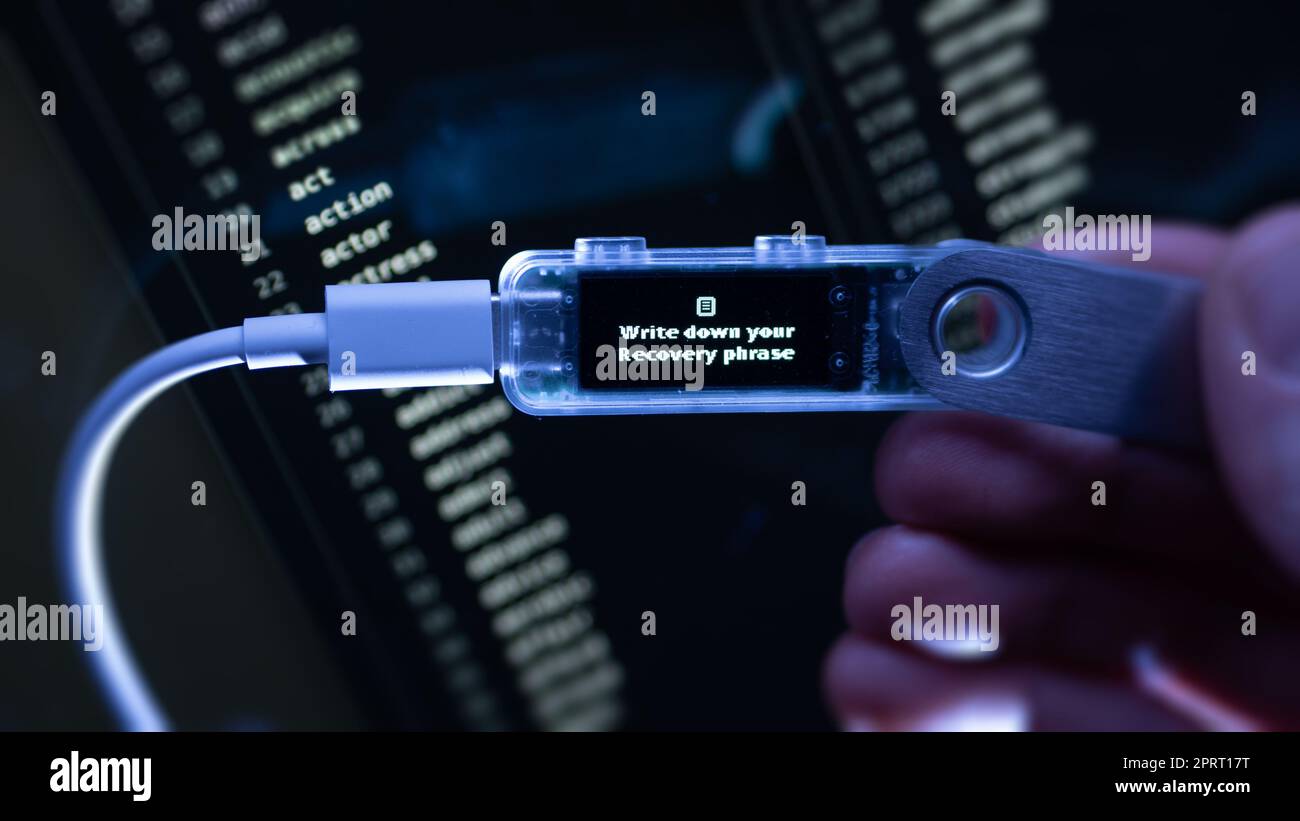 Focus on the screen of an hardware wallet Ledger, the Metamask logo in ...