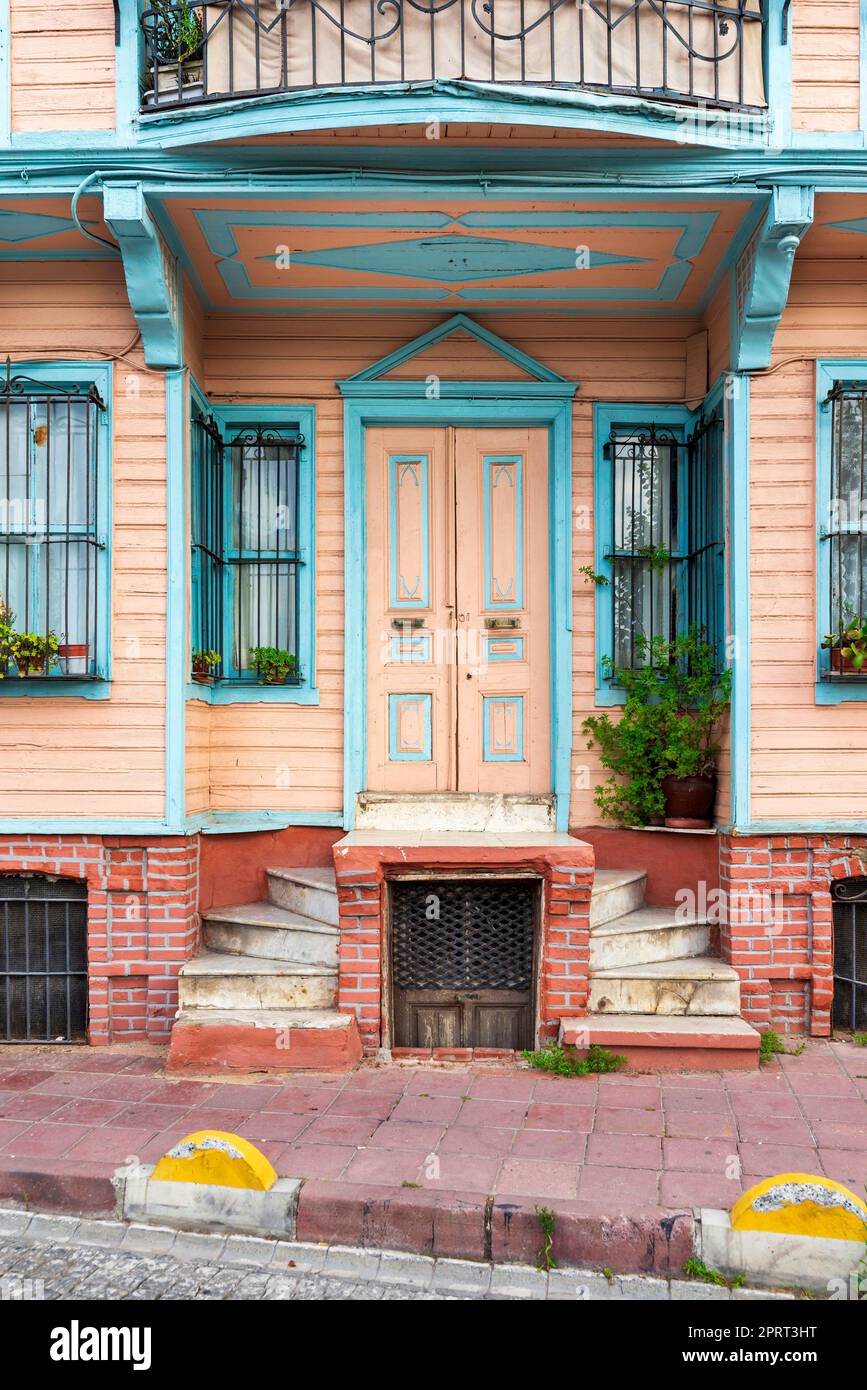 Old colorful wooden residential building with door, wrought iron ...