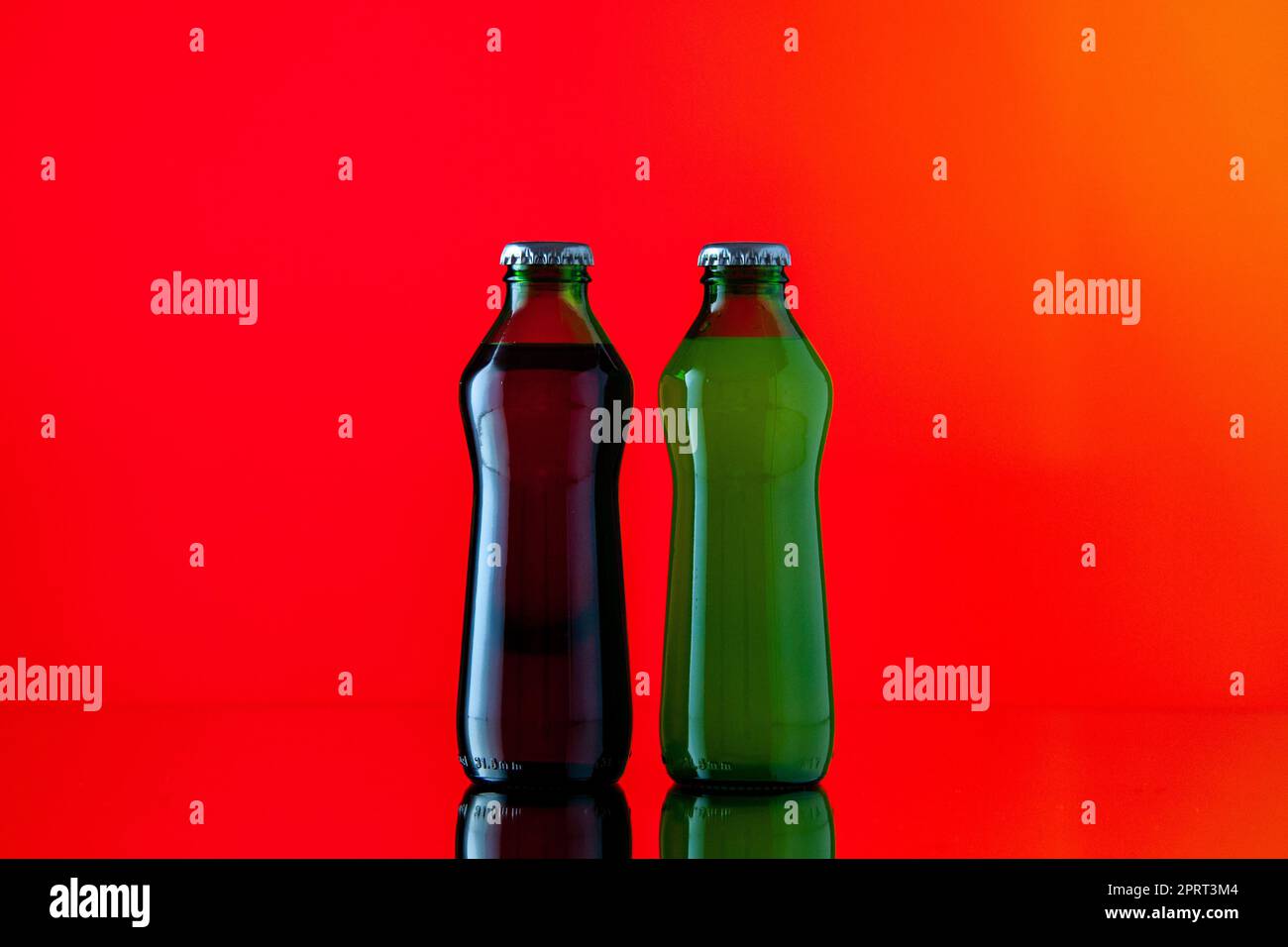 front view soda drink glass bottles on red isolated background Stock ...