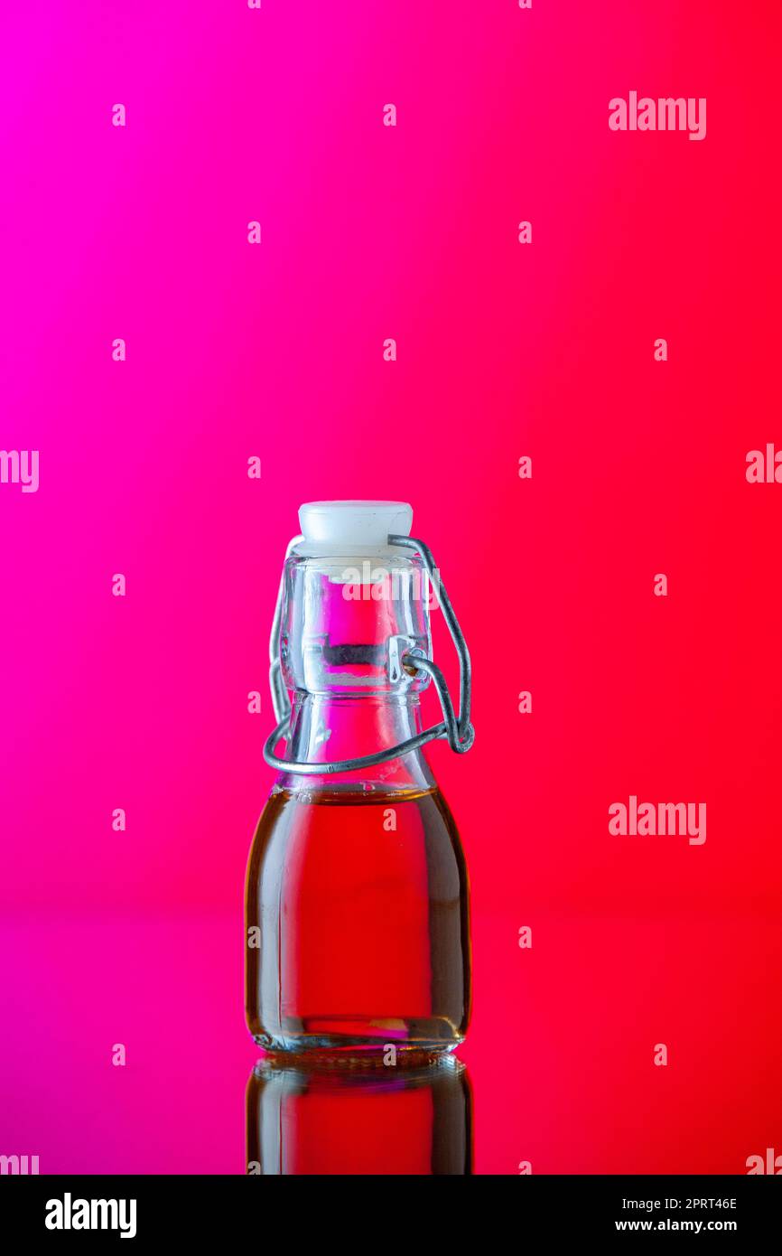 front view bottle with oil on light red background Stock Photo - Alamy