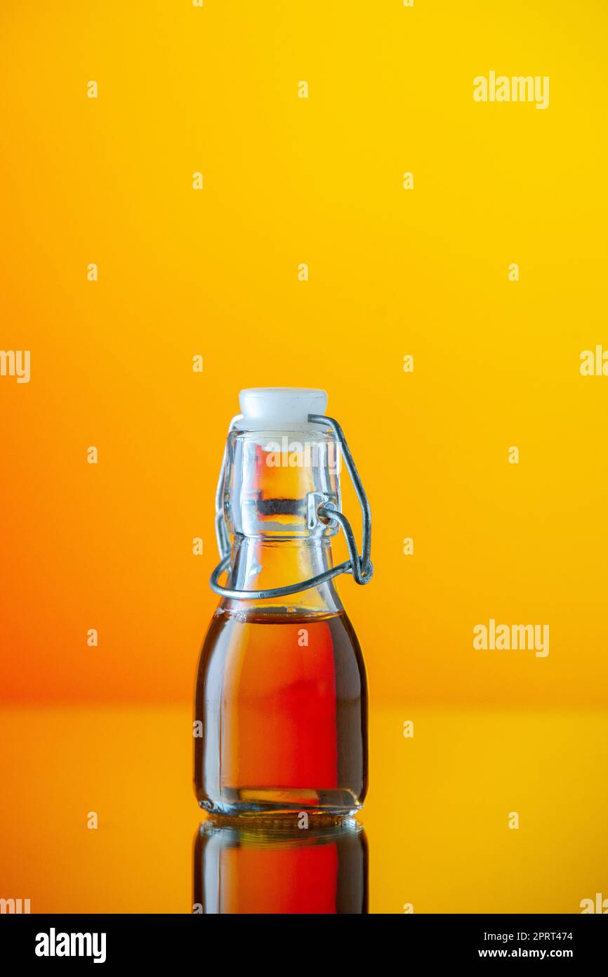 front view bottle with oil on orange background Stock Photo - Alamy