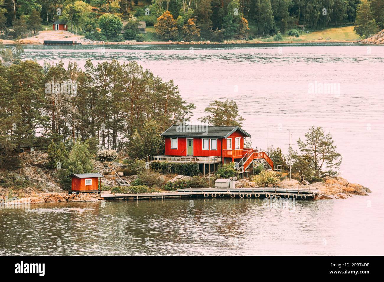Sweden. Many Beautiful Red Swedish Wooden Log Cabin House On Rocky ...