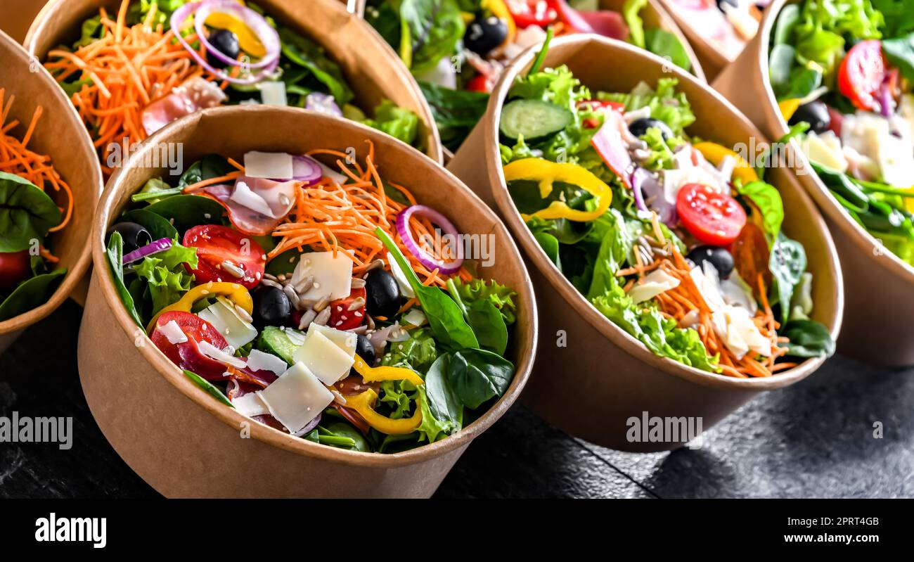 Round paper boxes with pre-packaged vegetable salads ready for sale ...
