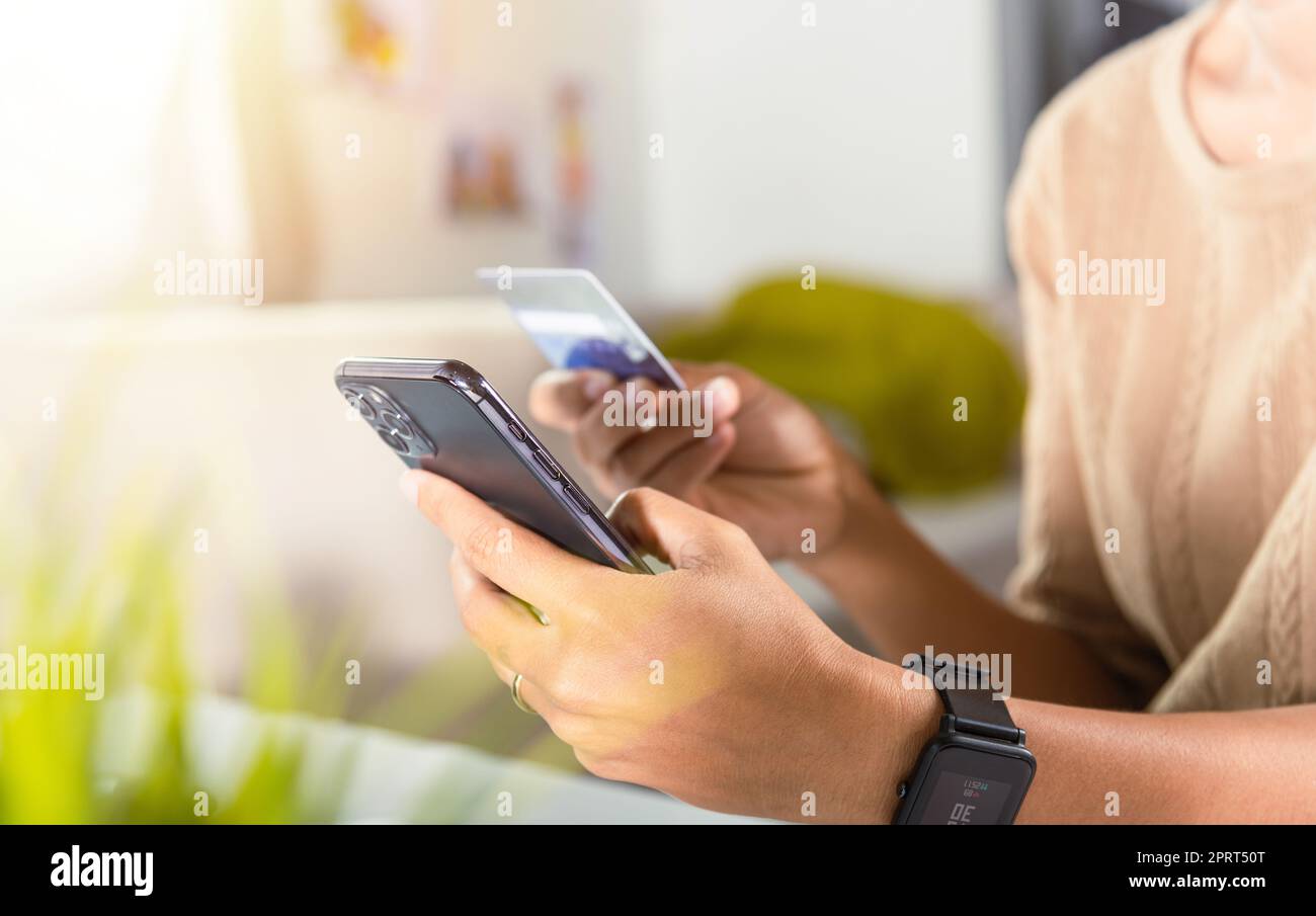 Woman hands holding credit card and smartphone with product purchase at ...