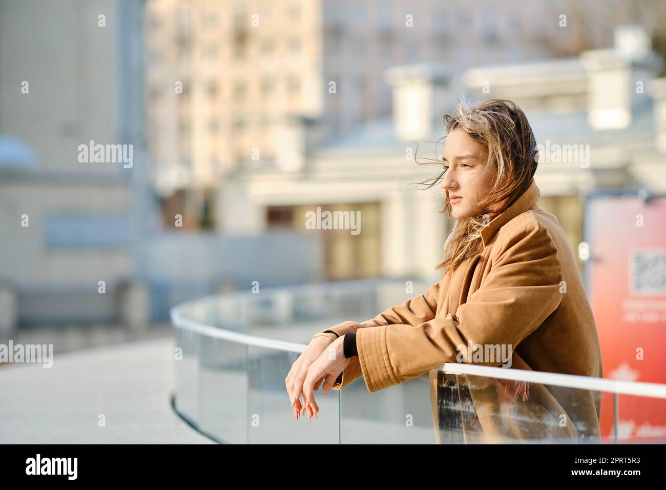 Cute young woman standing in profile at observation deck Stock Photo ...