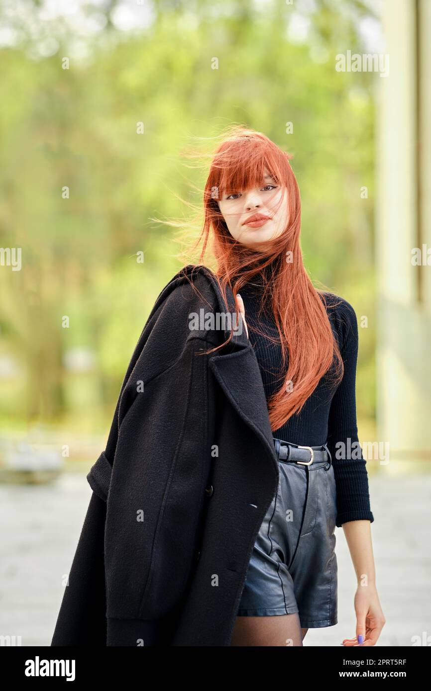 Woman windy day red coat hi-res stock photography and images - Alamy