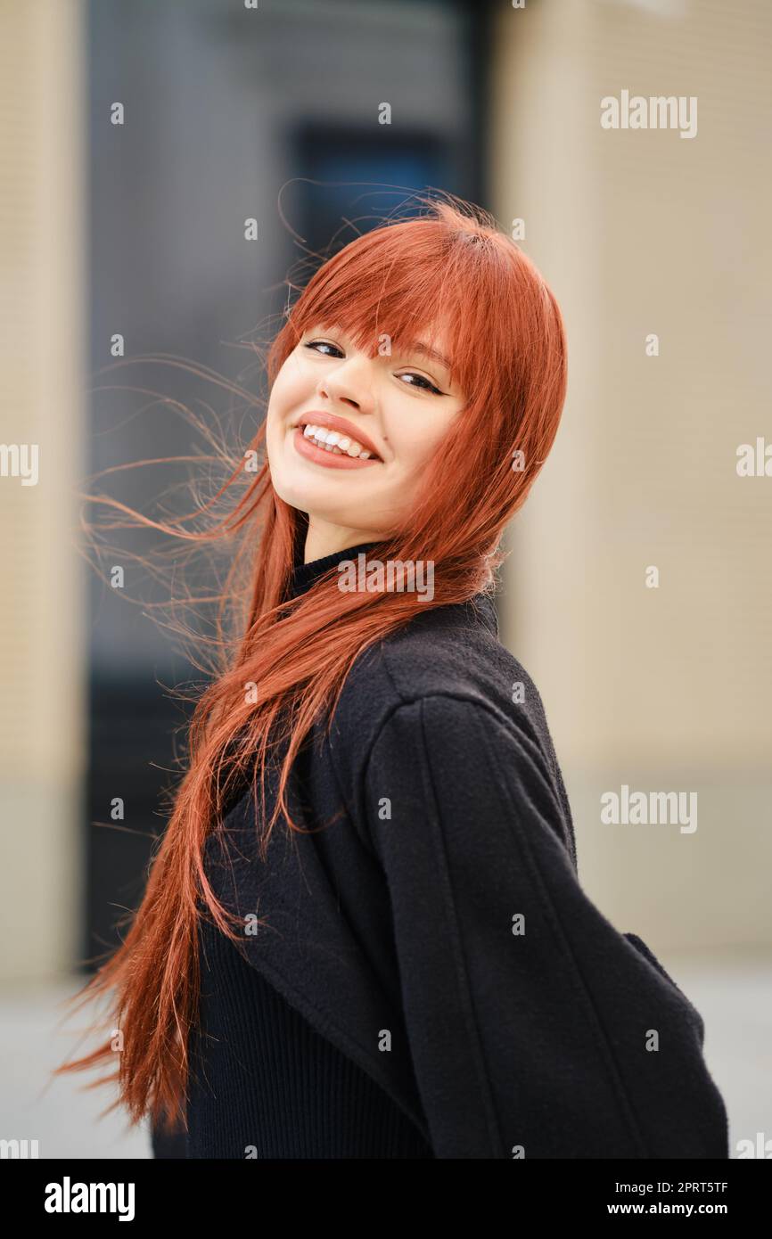 Street portrait of a happy young red-haired woman in a windy day Stock ...