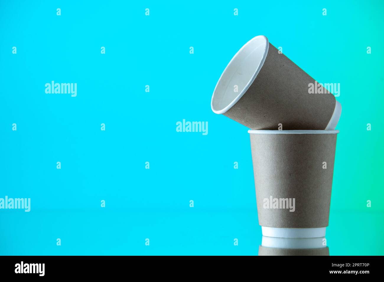 front view two paper water cups stacked on top of each other on neon ...