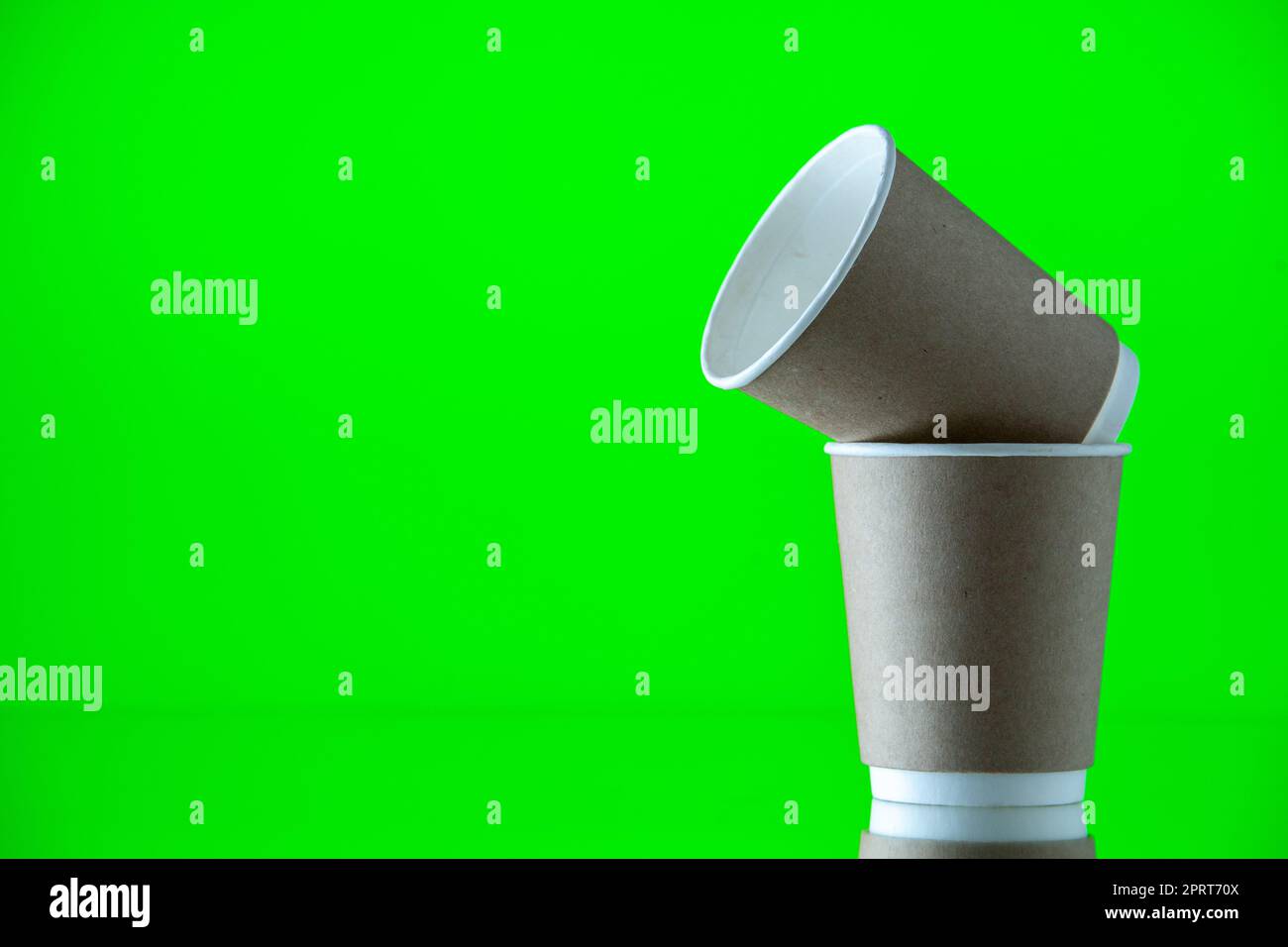 front view two paper water cups stacked on top of each other on neon ...