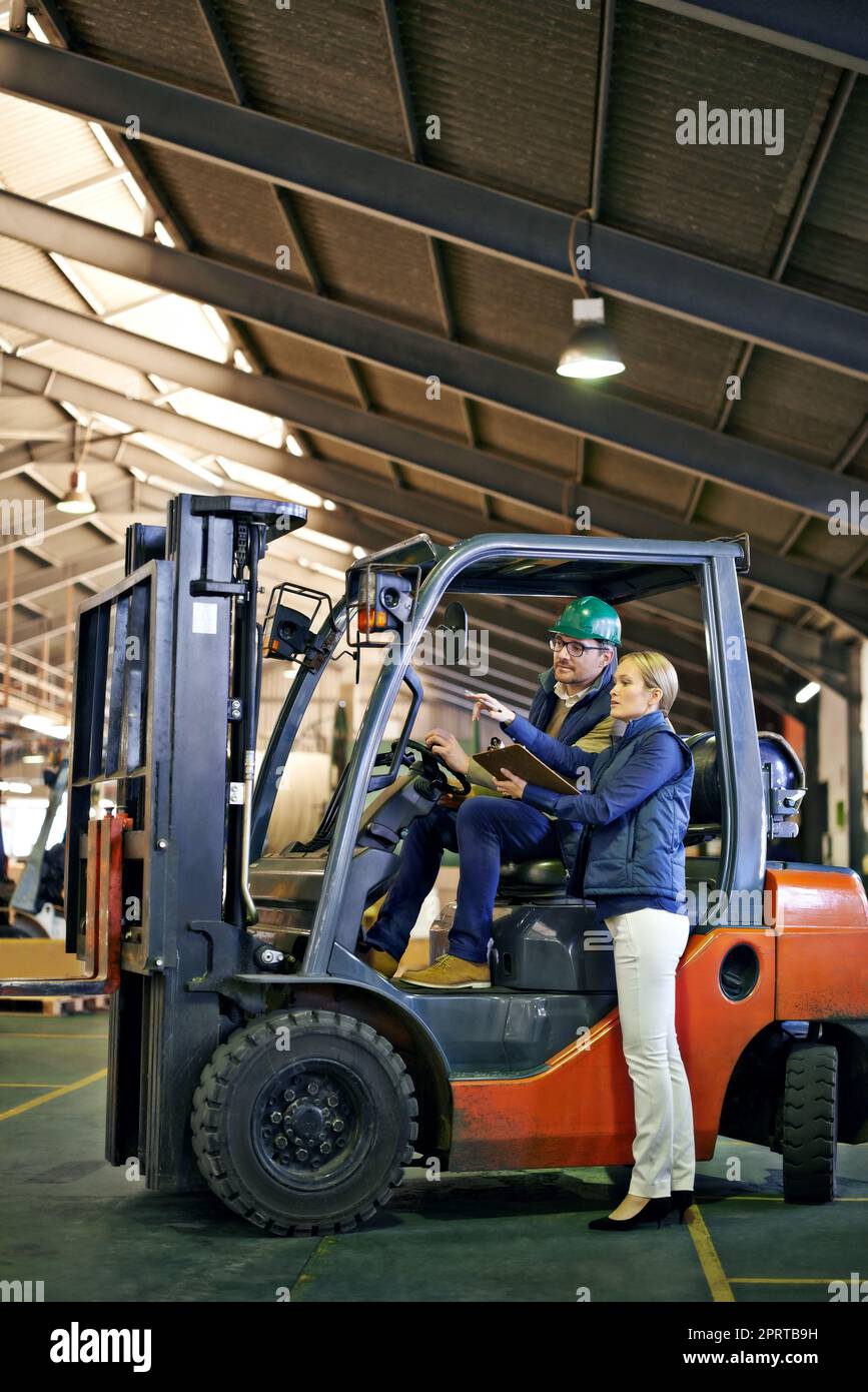 Its down over that way. Full length shot of two factory workers in a ...