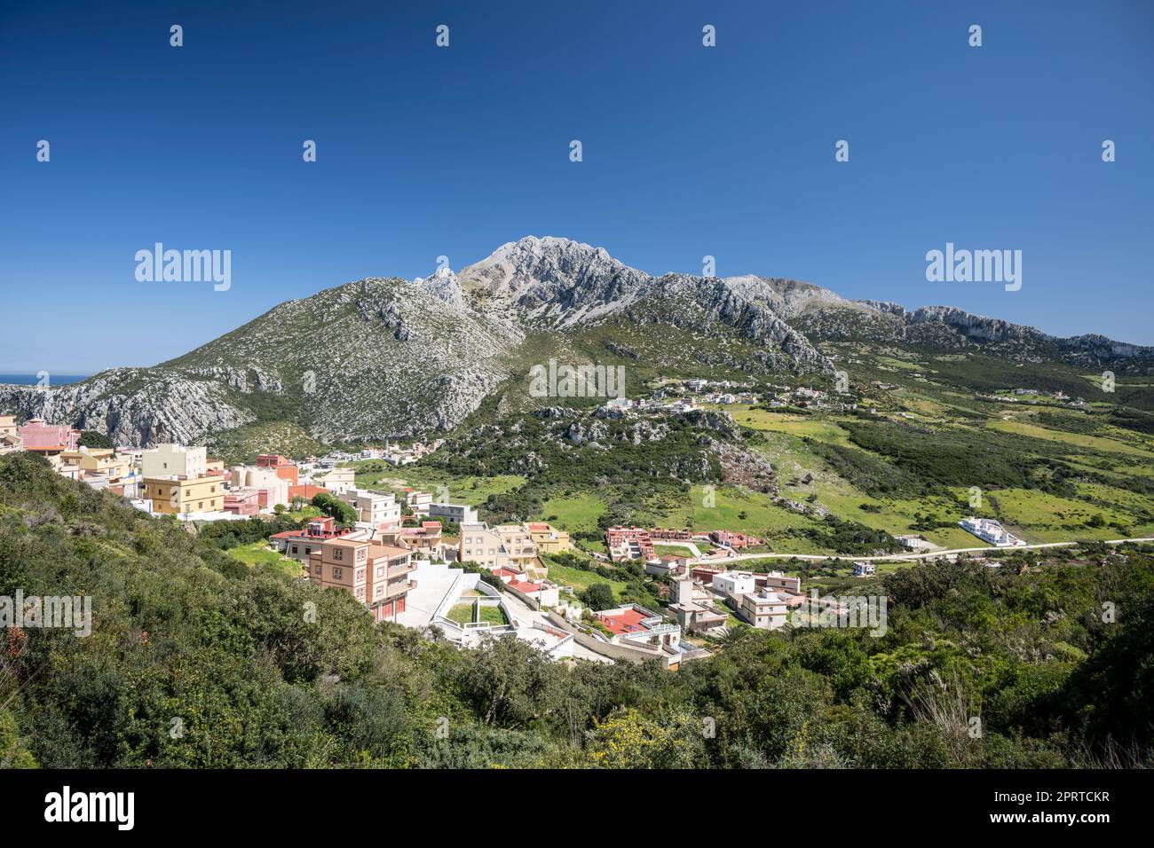 View of the coastal village of Fahs Anjra with the Jebel Musa peak in ...