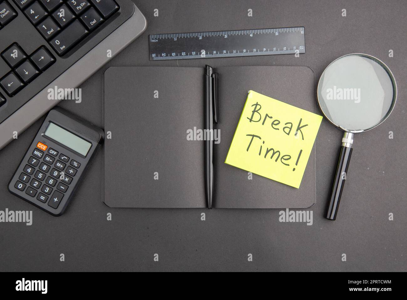 top view black notebook pen keyboard break time written on note paper ...