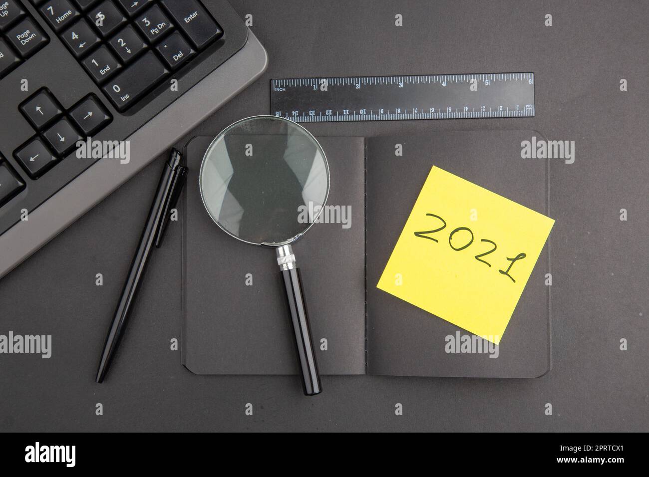 top view black notebook pen keyboard written on note paper lupa ruler ...