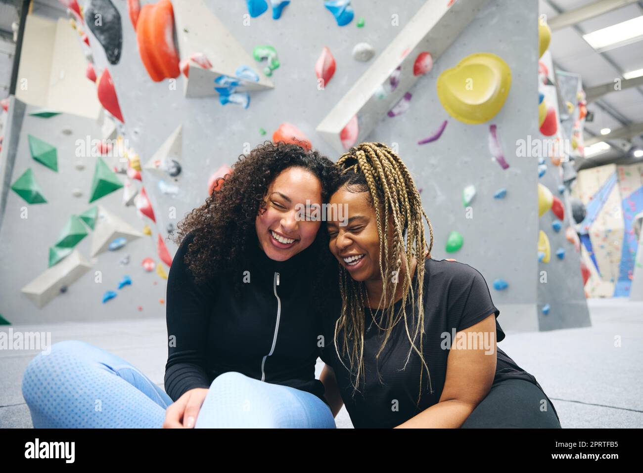 Two Smiling Female Friends Having Fun Laughing As They Try Climbing ...