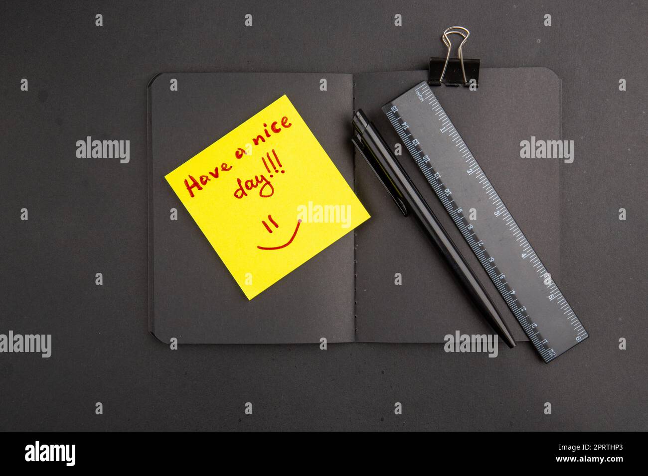 top view black notepad have a nice day written on note paper ruler pen ...