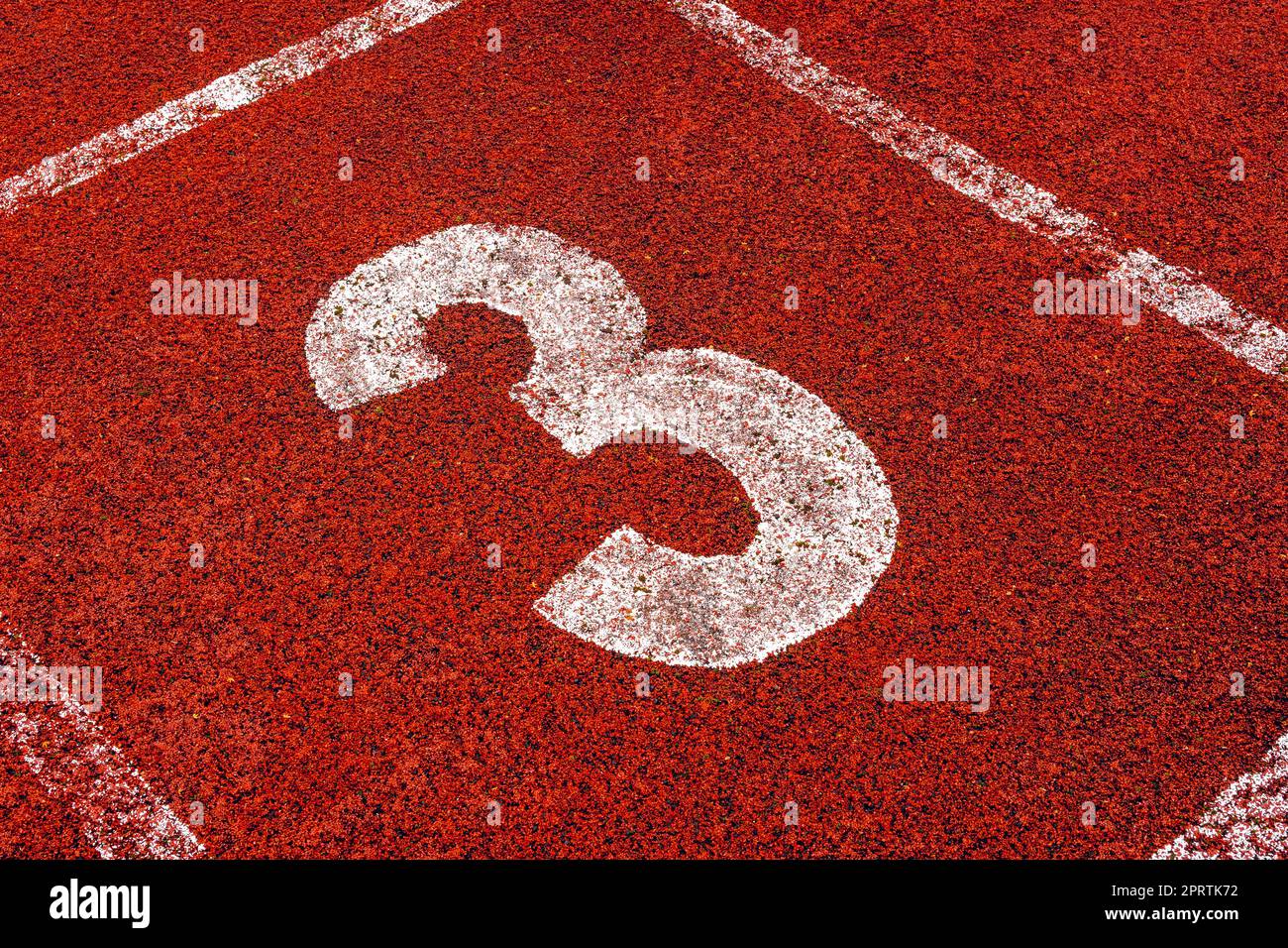 The number 3 at start point of running track Stock Photo - Alamy