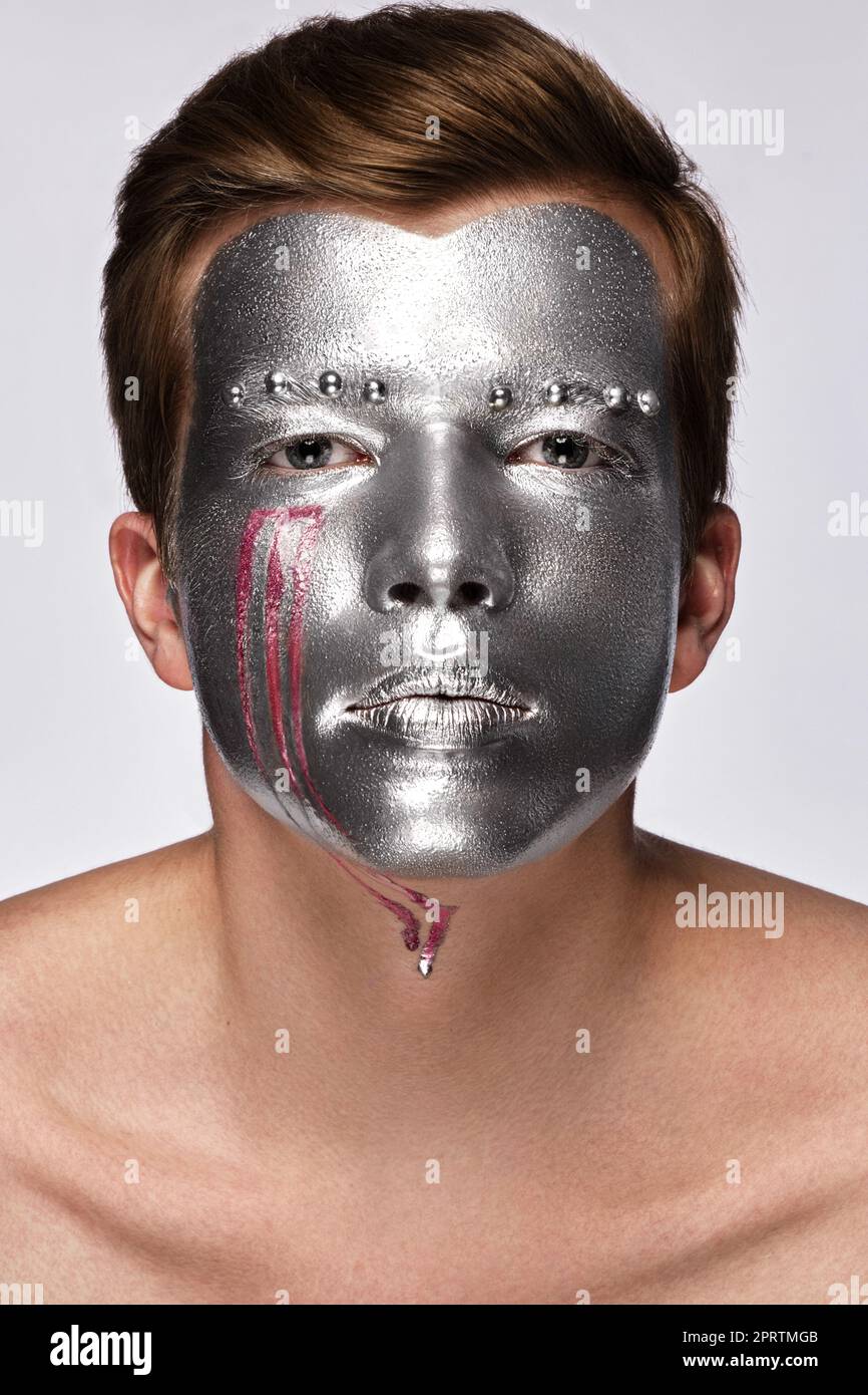 Young man with art creative art make-up with silver paint on his face ...