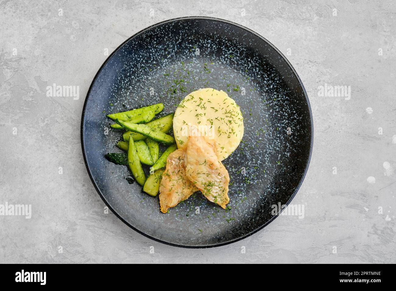 Top view of fried zander fillet with mashed potatoe and pickled ...