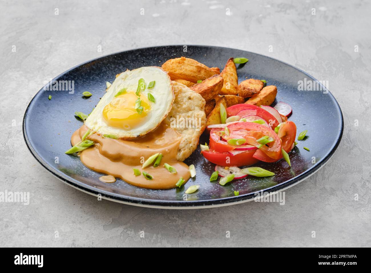 Chopped pork sirloin with fried potato wedges, egg, tomato and radish ...